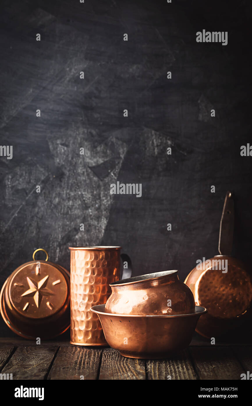 Different kind of vintage copper cookware over dark background Stock ...