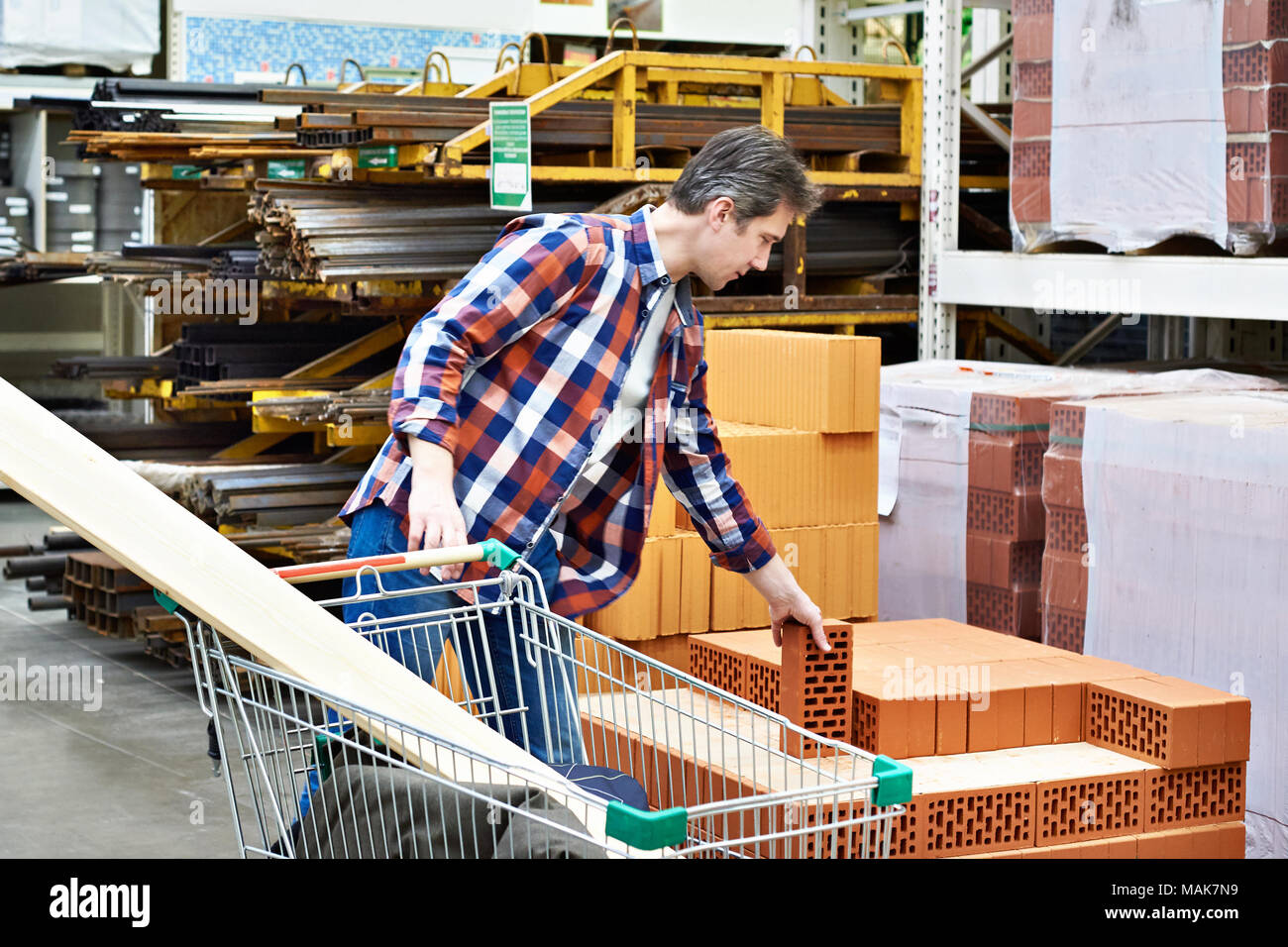 Man chooses and buys bricks in a construction supermarket Stock Photo ...