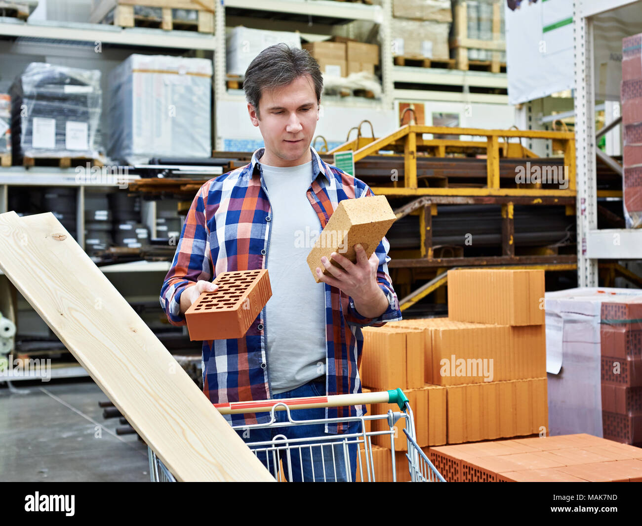 Man chooses and buys bricks in a construction supermarket Stock Photo ...
