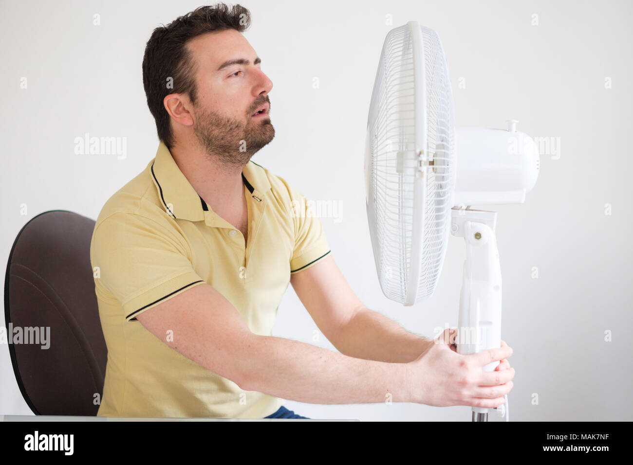 Electric fan person cooling hi-res stock photography and images - Alamy