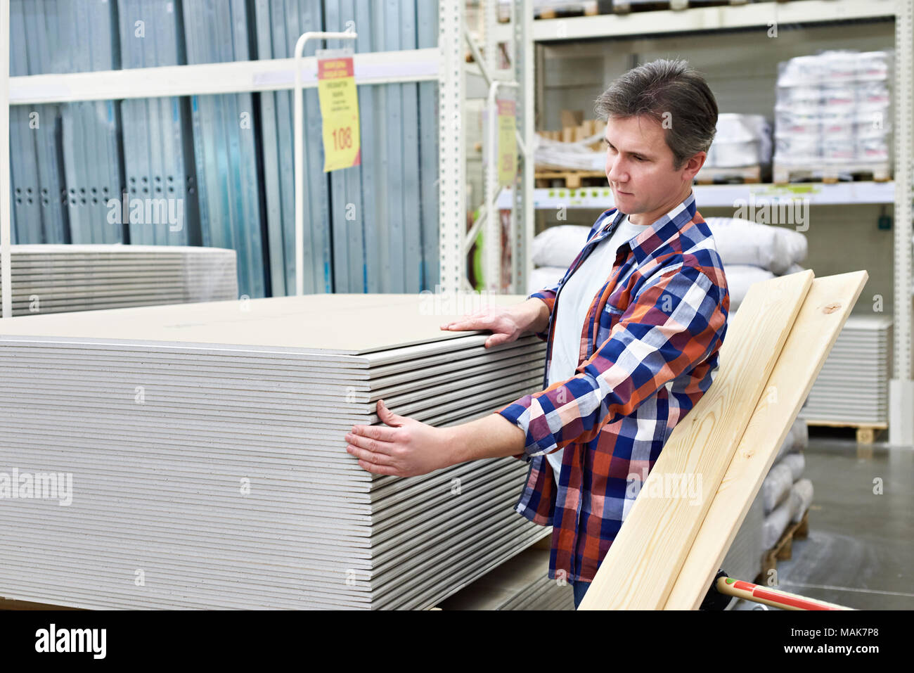 Man chooses and buys drywall in a construction supermarket Stock Photo ...