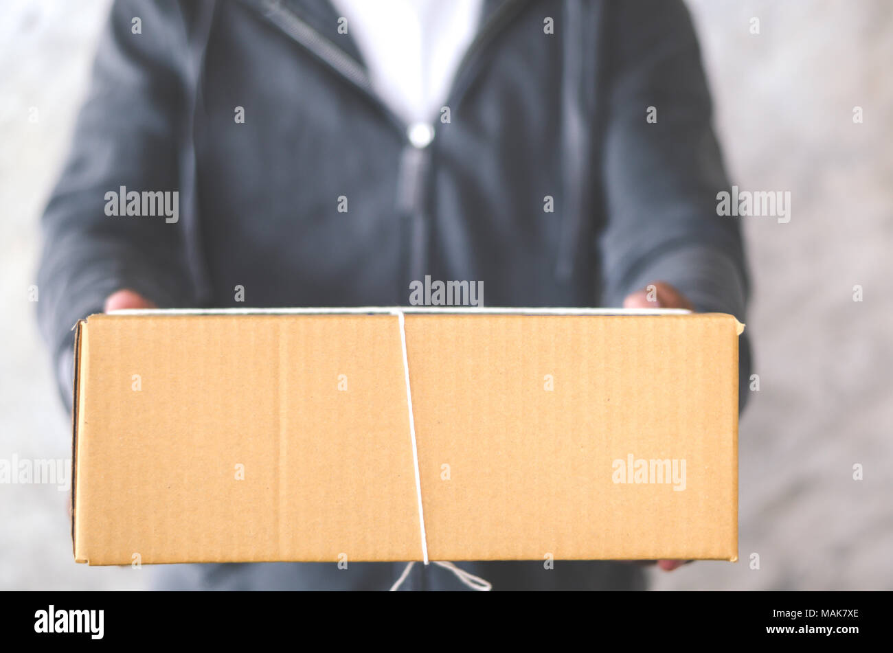 delivery man carrying a parcel box Stock Photo - Alamy