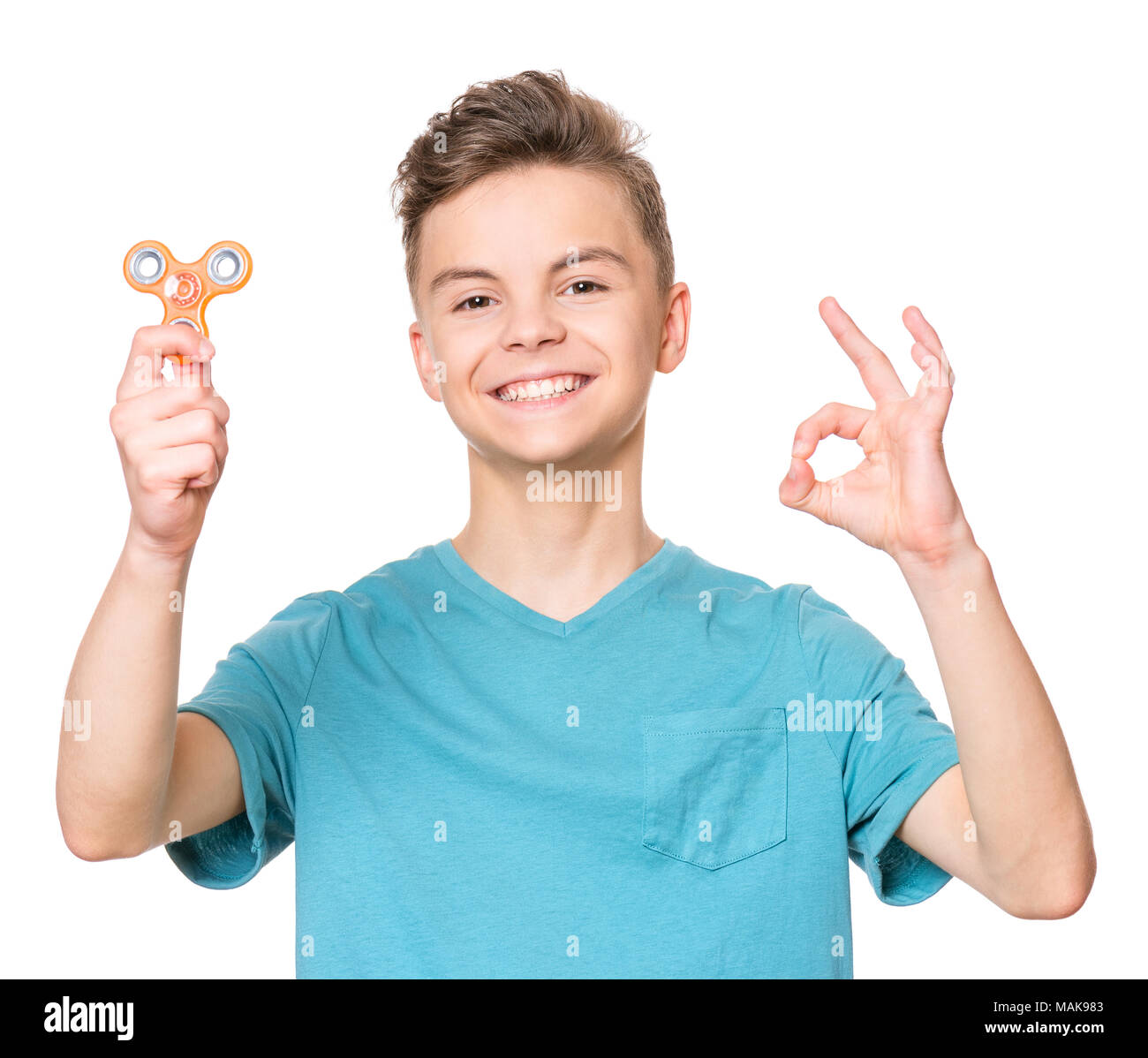Teen boy with spinner toy Stock Photo - Alamy