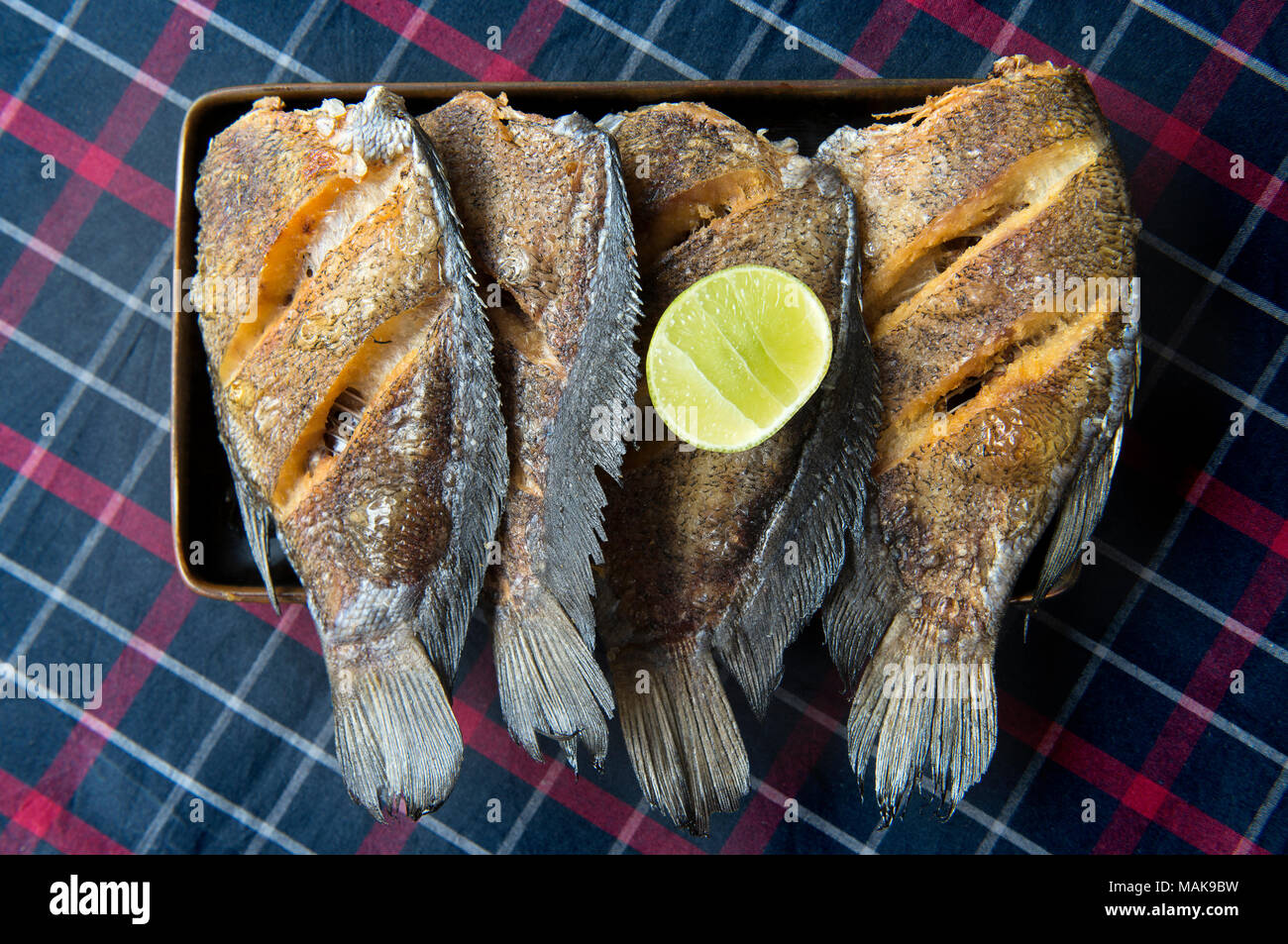 Fried salted dried damsel fish servr with lemon in Thai style Stock ...