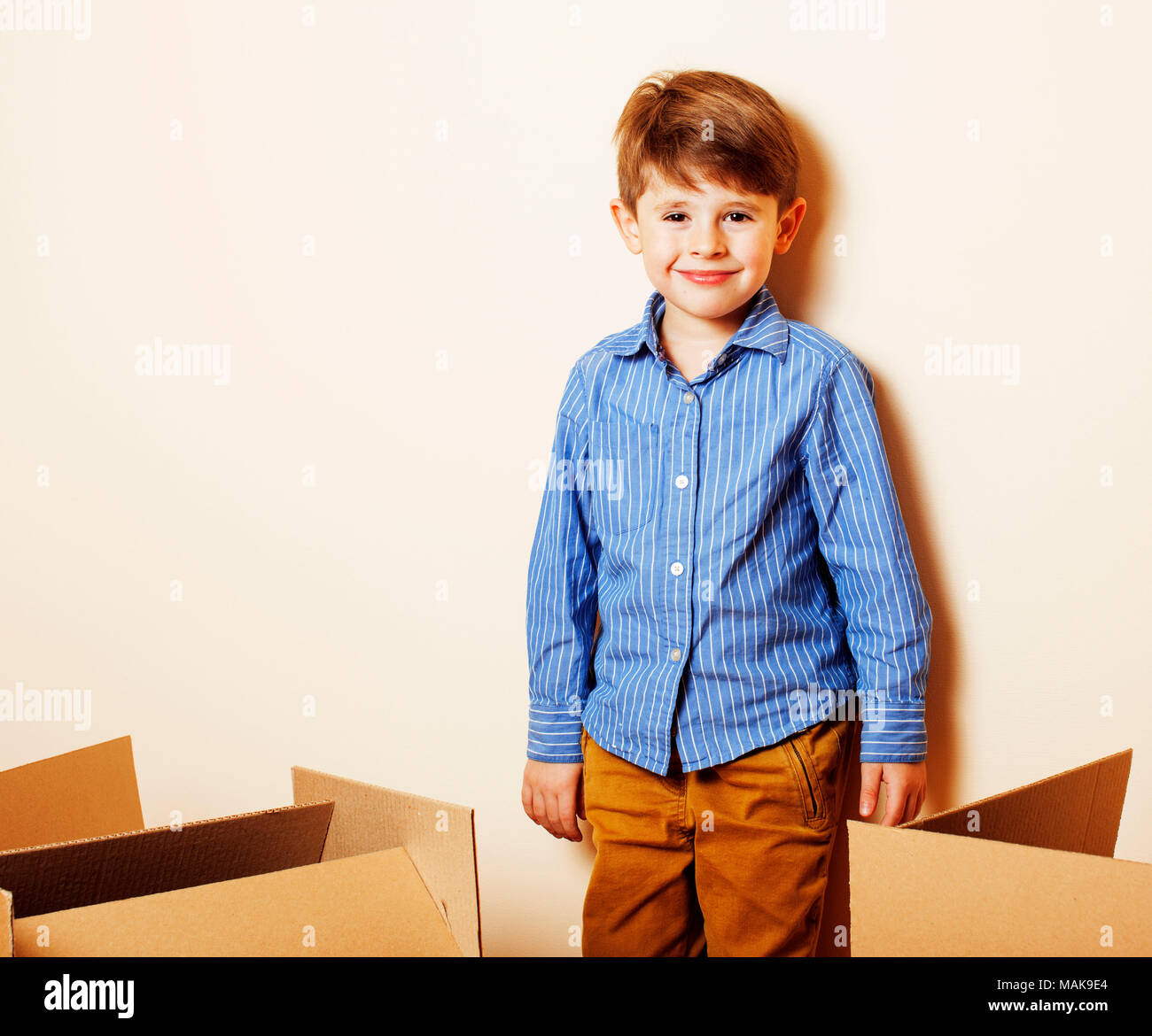 little cute boy in empty room, remoove to new house. home alone Stock ...