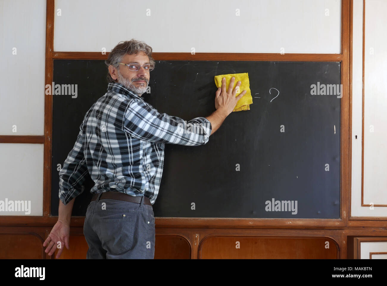 teacher wipes a blackboard after the lesson Stock Photo - Alamy