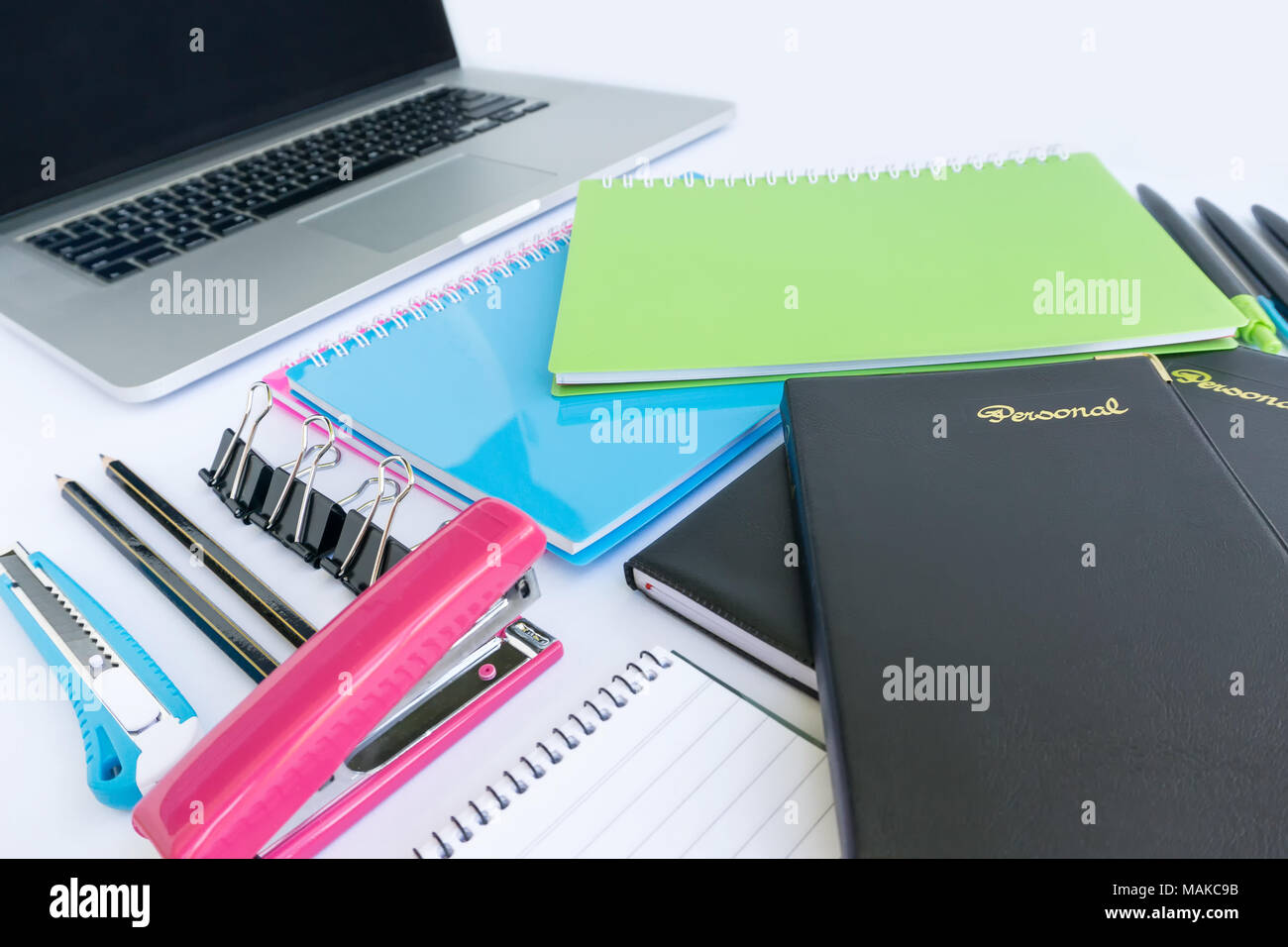 Multiple stationery items for office and school and a laptop from ...