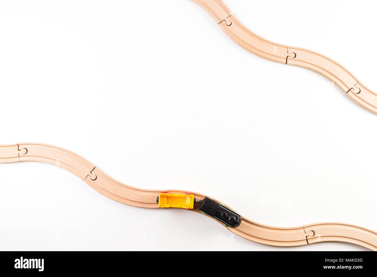 Toy train and curve wooden railways on white background Stock Photo - Alamy