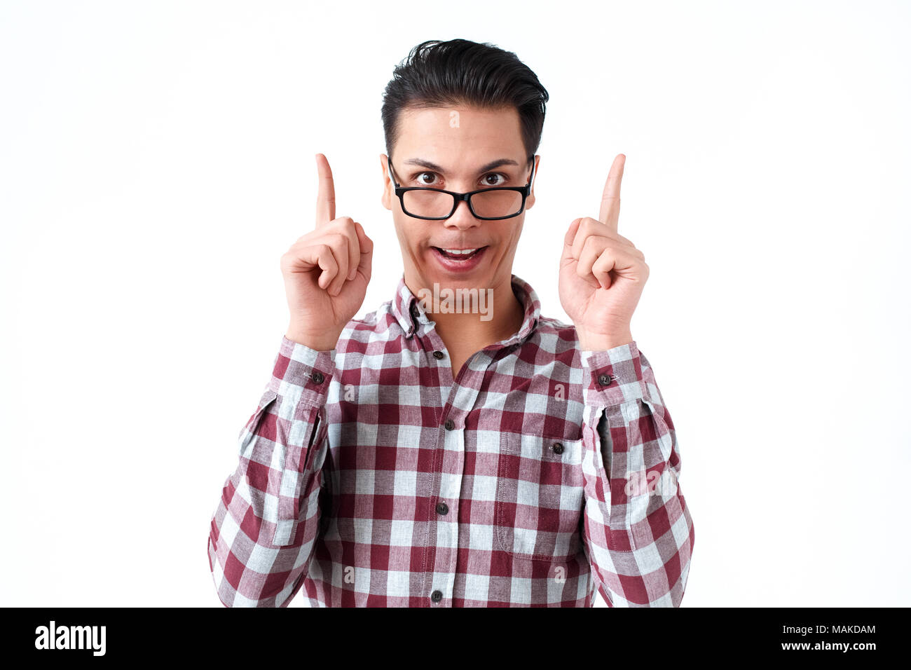 Crazy man in shirt pointing fingers up at copy space. Funny emotions ...