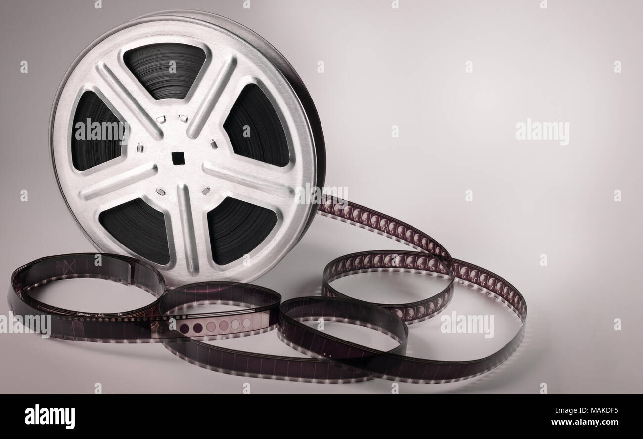 Old motion picture film reel on brown background Stock Photo - Alamy