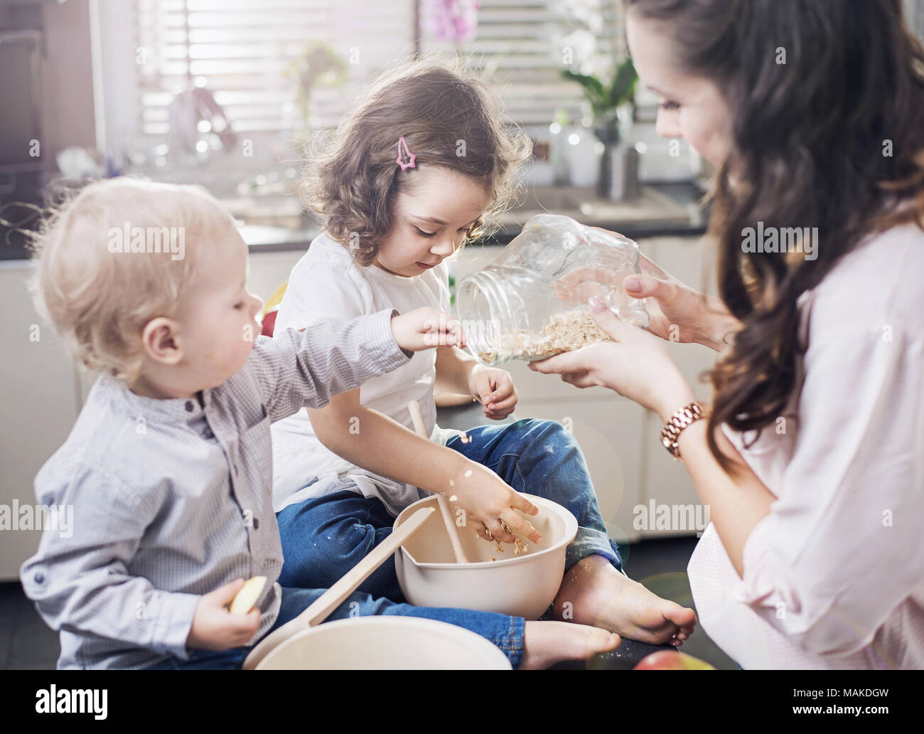 Mother baking a sweet cake with her children Stock Photo - Alamy