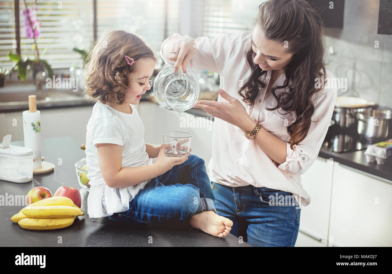 Child filling glass hi-res stock photography and images - Alamy