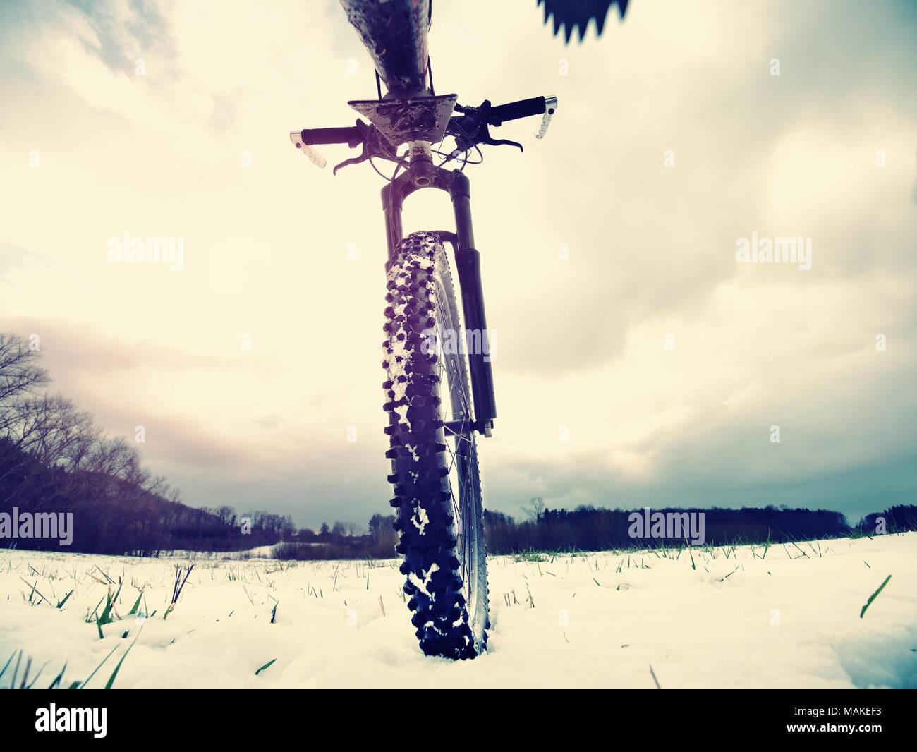Winter snow riding on mountine bike. Extreme weather, slippery road in ...