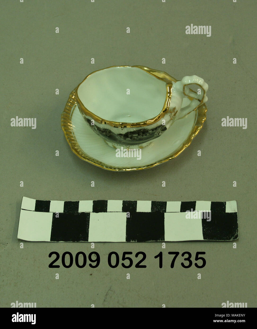 White shell shaped ceramic cup and saucer black transfer image on the ...