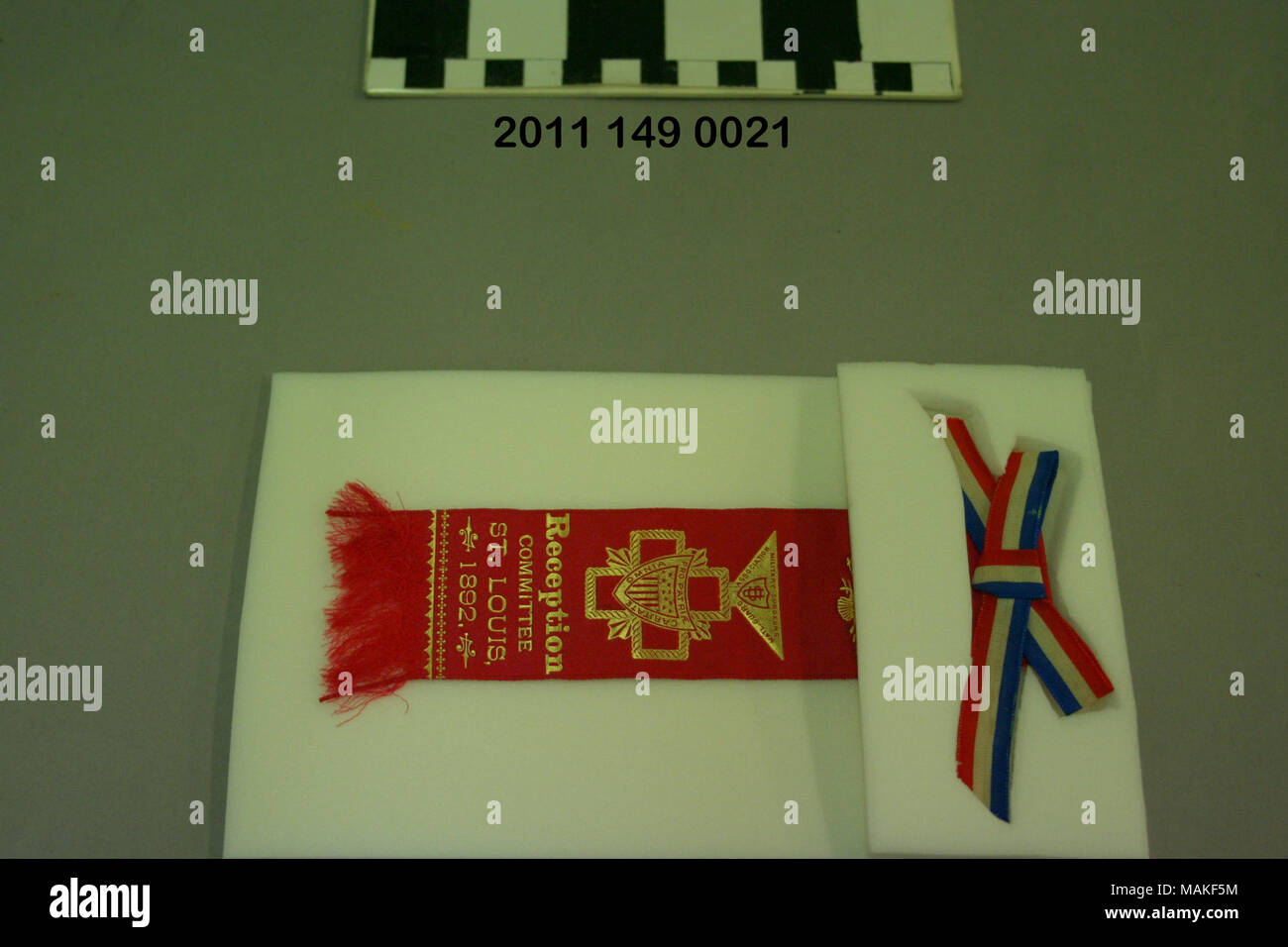 Red ribbon stamped with gold lettering Title: Red Ribbon Stamped with ...