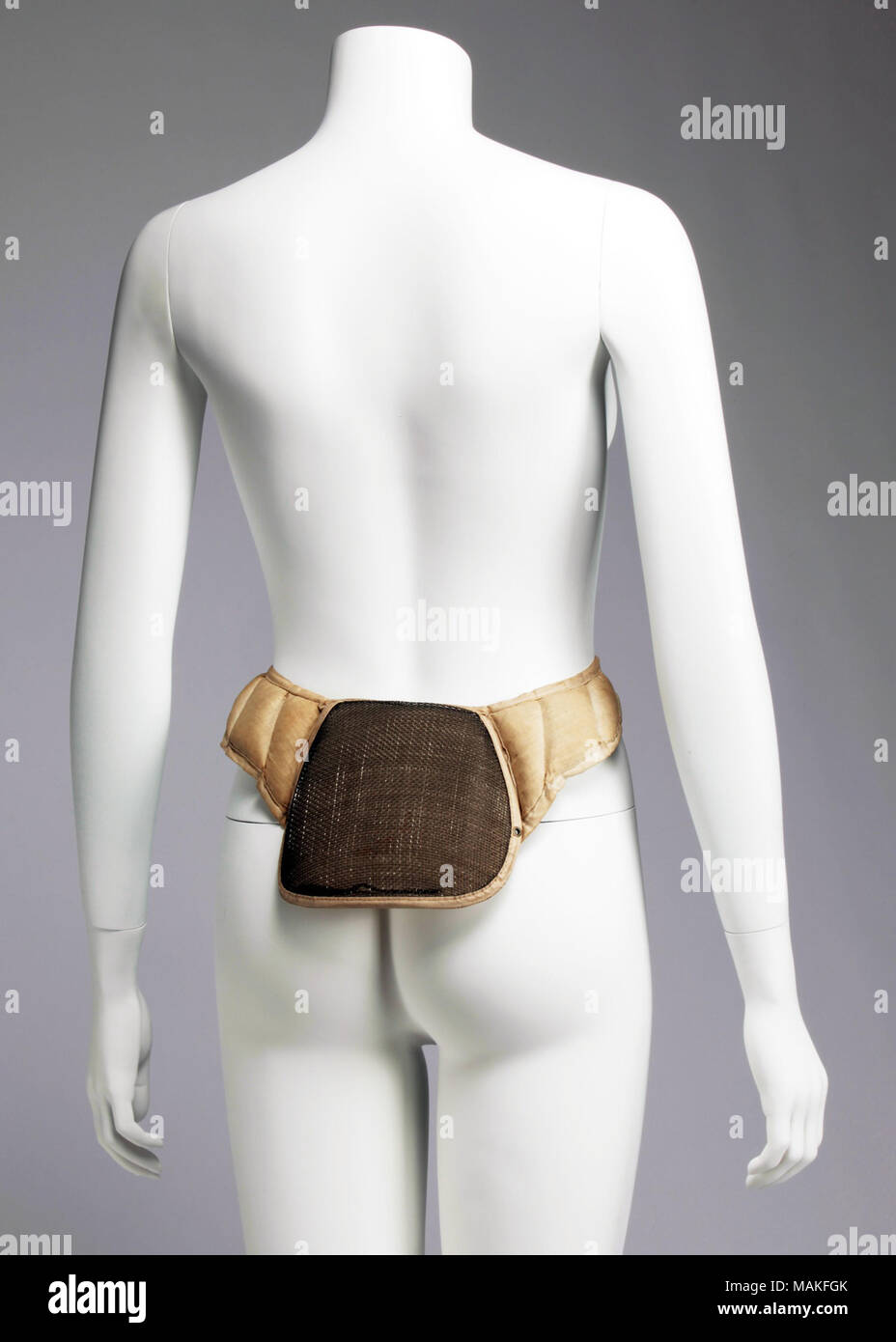 Woman's small bustle pad. Wire mesh forms and inverted keystone shape ...