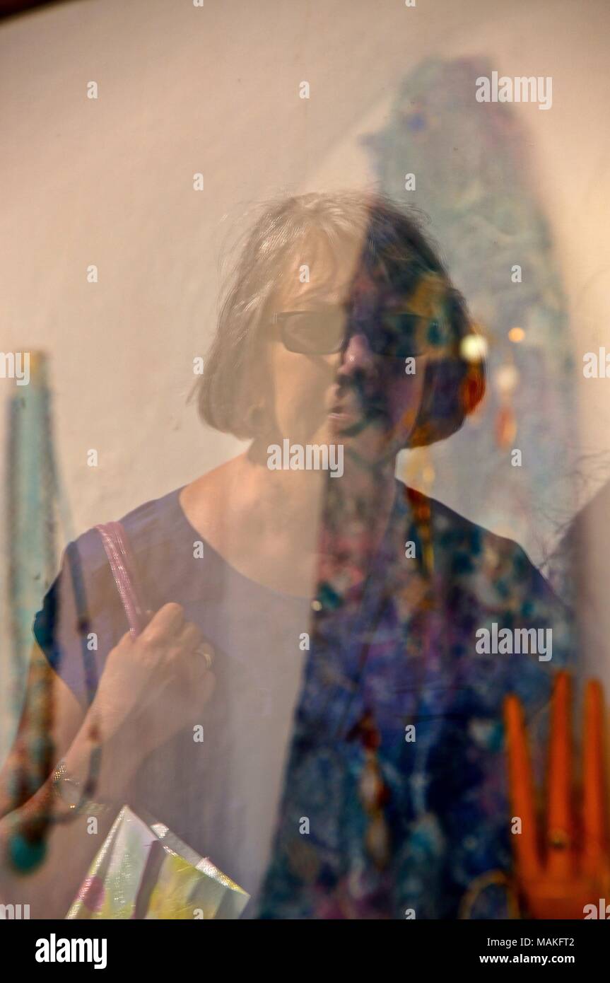 Woman shopper in window - reflection Stock Photo - Alamy