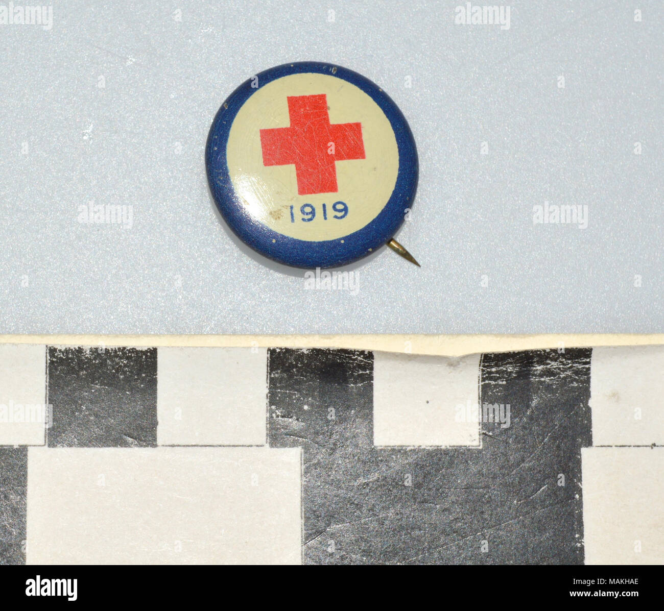 1919 American Red Cross pin. Features the date and a red cross on a ...