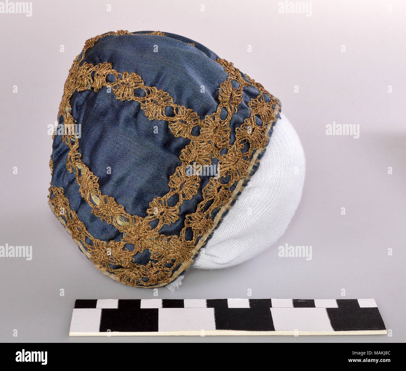 Dark blue satin infant cap with gold metallic trim. Title: Blue Infant ...