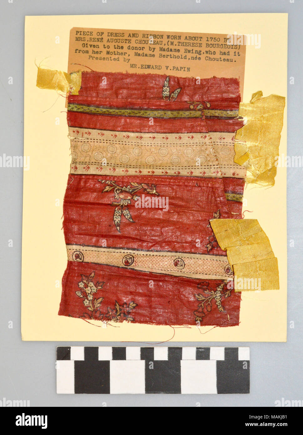 Piece of a red cotton dress and yellow ribbon worn by Marie Therese ...