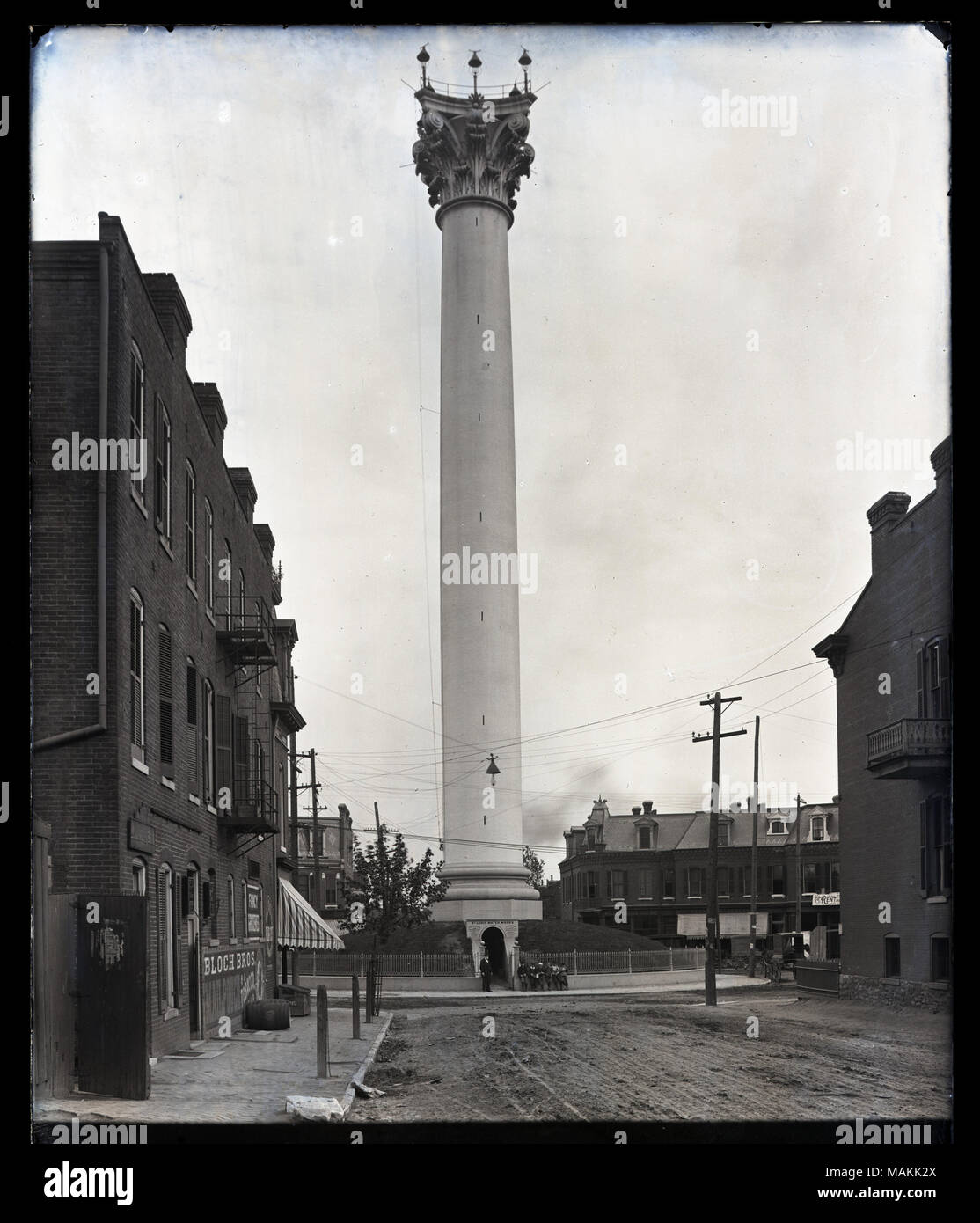 Vertical, black and white photograph showing a white water tower with ...