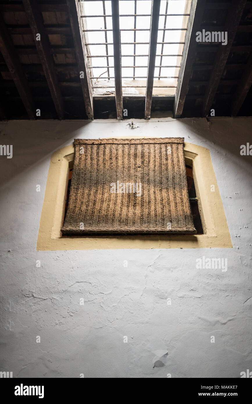 Traditional woven rush blind covering window Stock Photo - Alamy