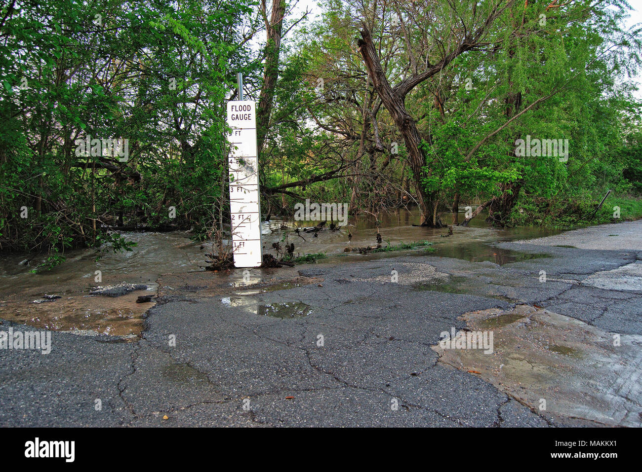 Flood waters going under a low crossing bridge road Stock Photo - Alamy