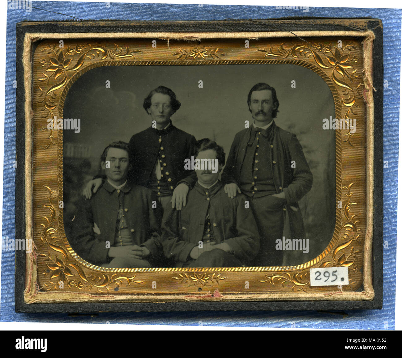 Cased tintype with four subjects facing forward, two standing and two ...