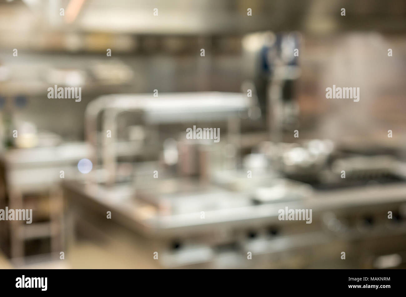 Defocused modern stainless steel hobs in commercial kitchen Stock Photo ...