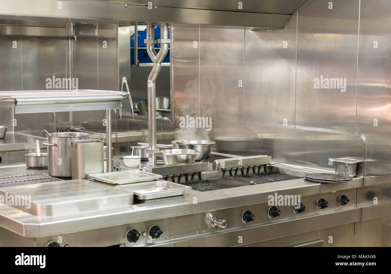 Modern stainless steel hobs in commercial kitchen Stock Photo - Alamy