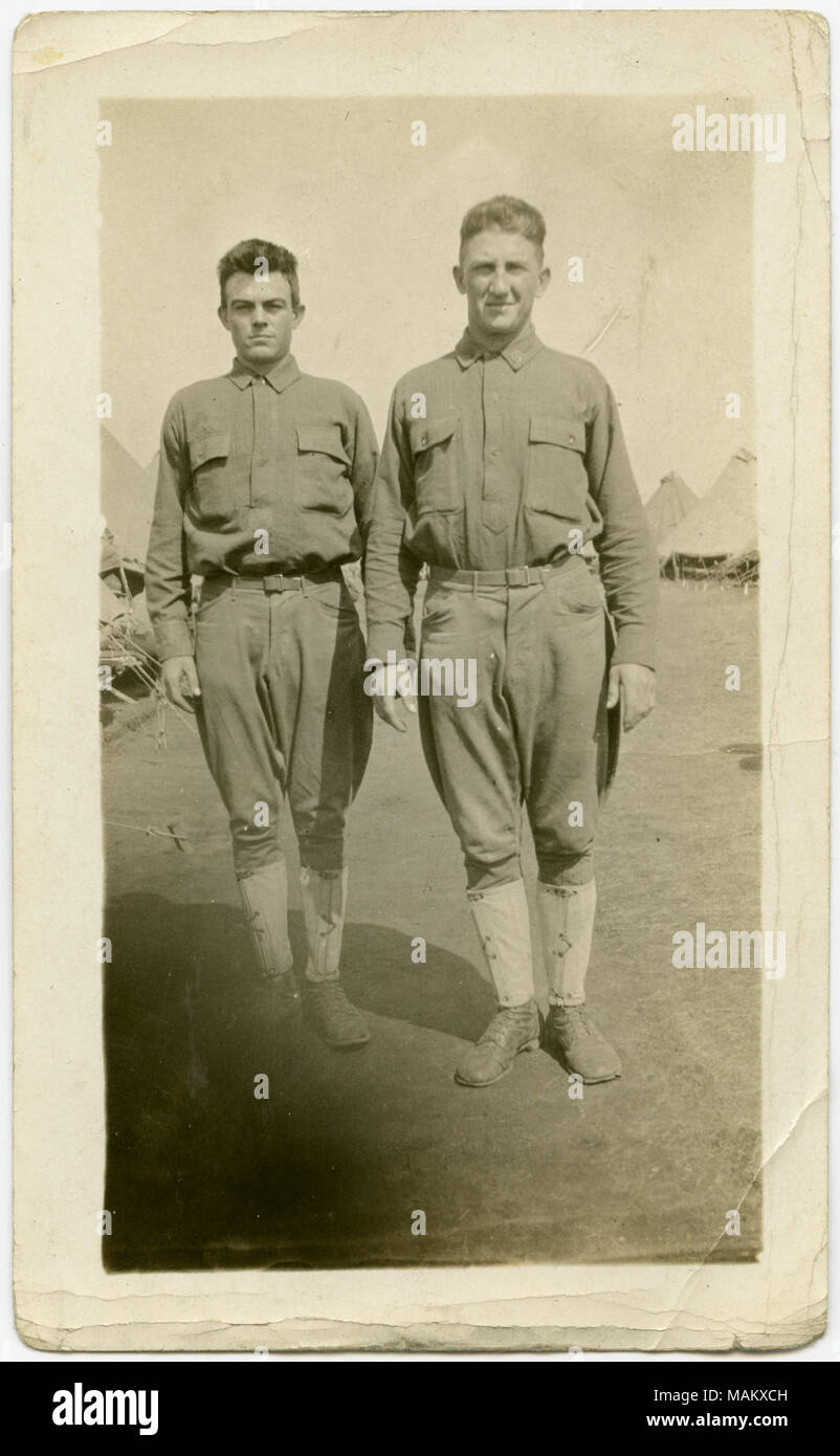 Vertical, sepia photograph showing two men wearing miltiary uniforms ...