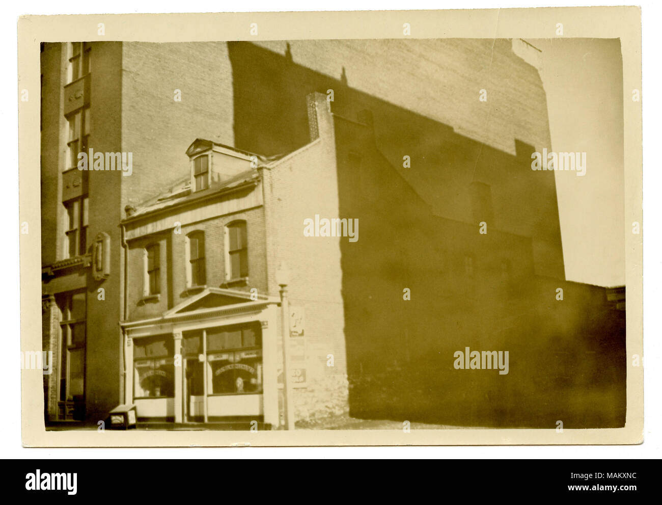 Horizontal, black and white photograph of a three story brick ...