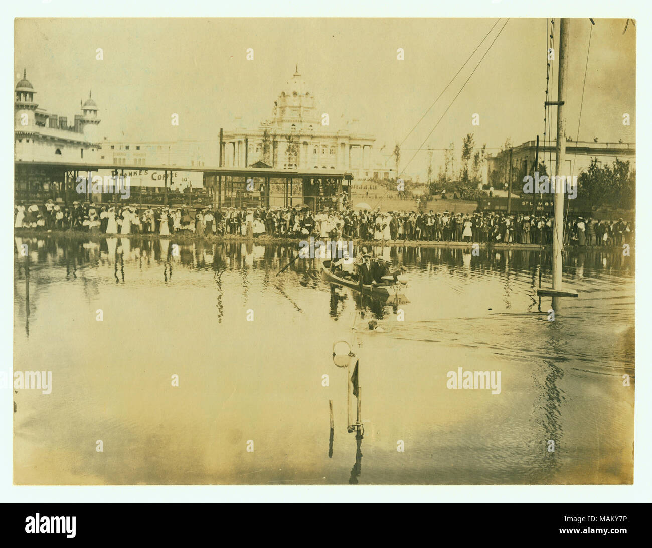 Horizontal photograph of a swimmer crossing a finish line. Men in a ...