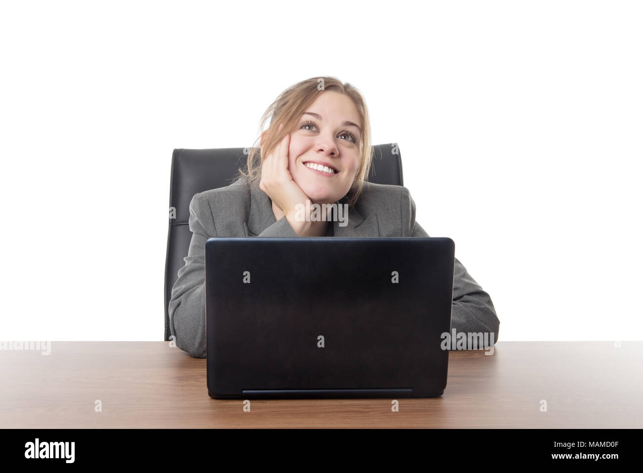 business woman sitting a a desk with a laptop computer in front of her ...