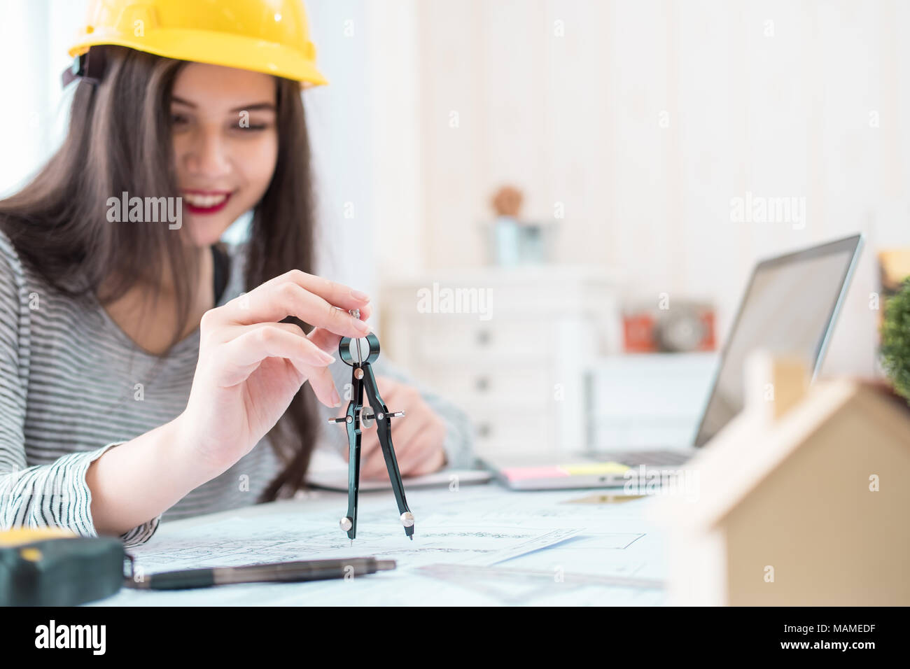 Architect or planner working on drawings for construction plans at a ...