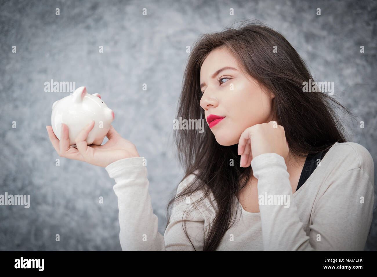 Beautiful young girl saving money for holiday season, saving money ...