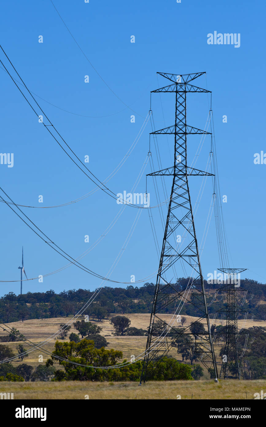 power pylons with wind farm turbines in the background at Inverell in ...