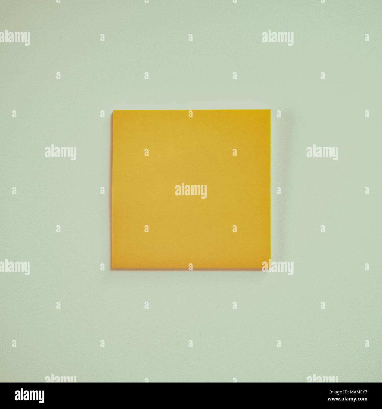 Yellow paper stick note on a white background Stock Photo - Alamy