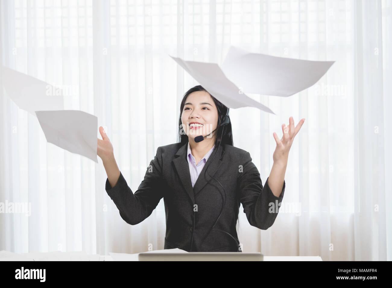 Woman papers throw laptop hi-res stock photography and images - Alamy