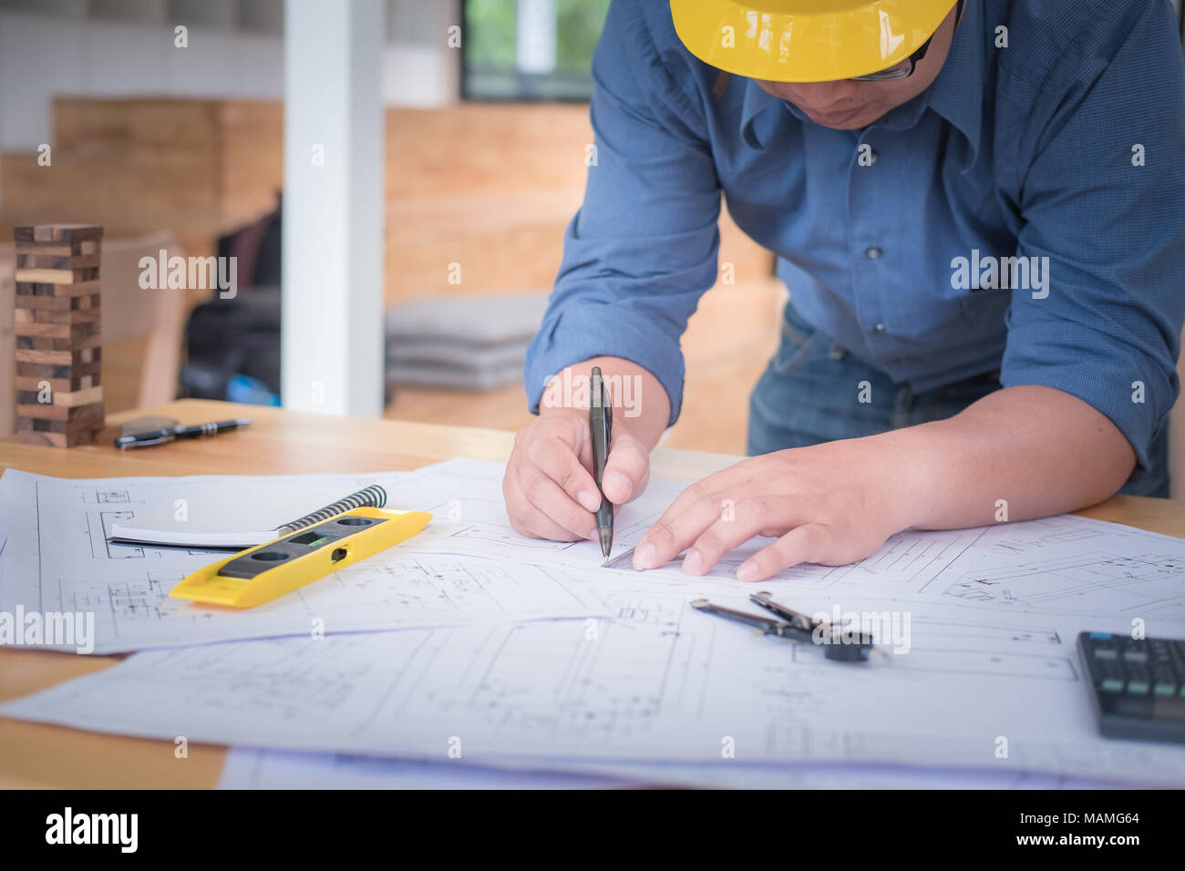 Architect or planner working on drawings for construction plans at a ...
