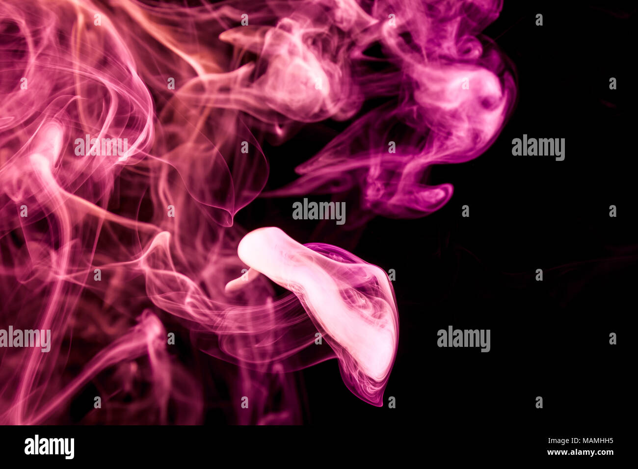Multi-colored smoke with clubs of red and pink on a black isolated ...