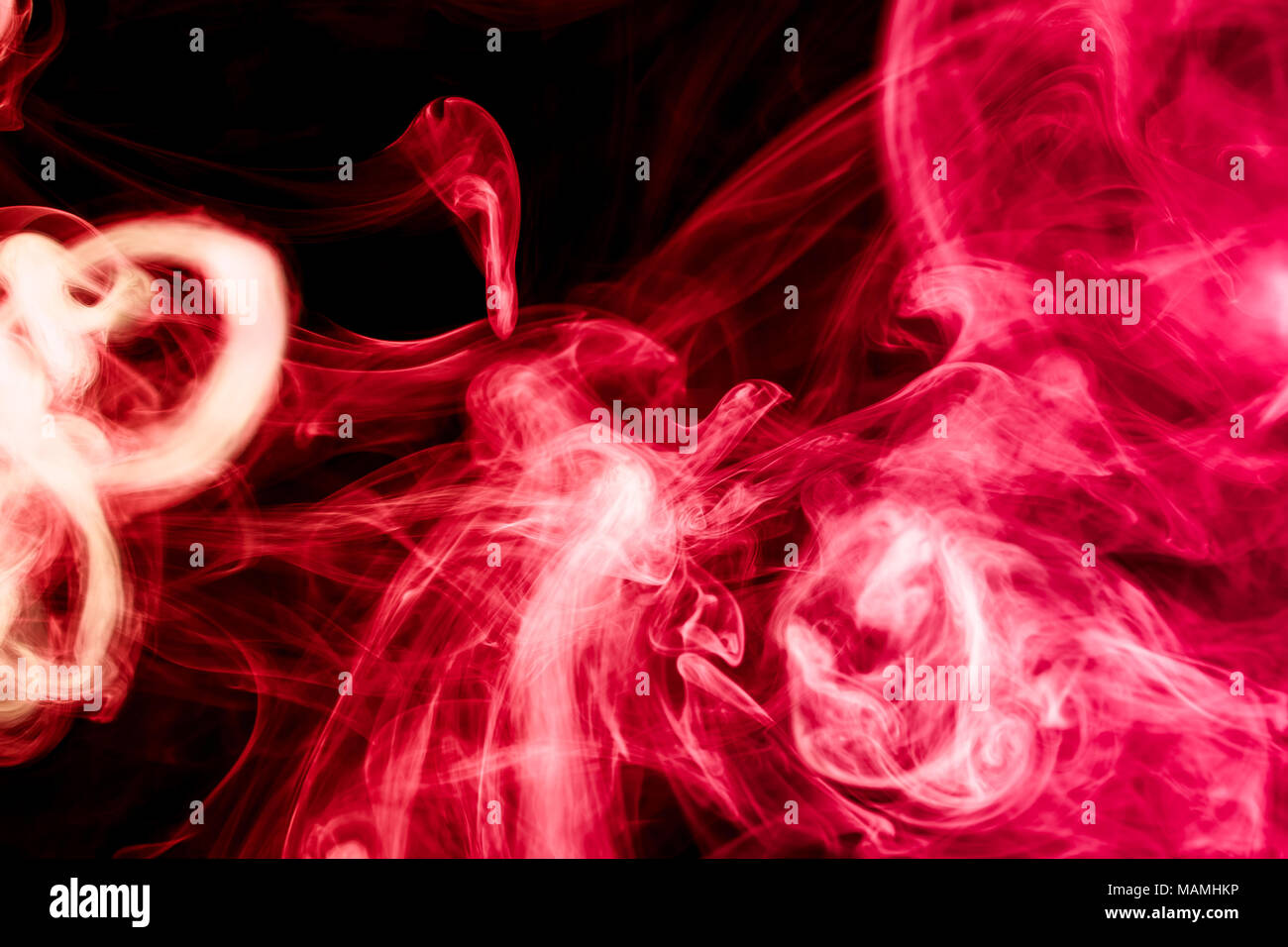 Red and pink cloud of smoke of black isolated background. Background ...