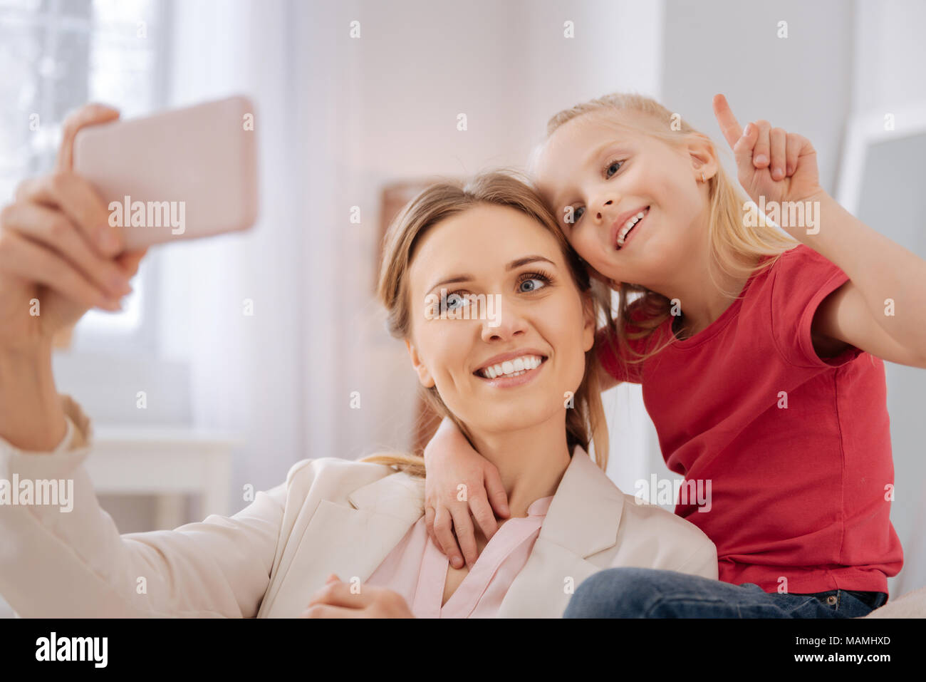 Happy positive mother and daughter taking a selfie Stock Photo - Alamy