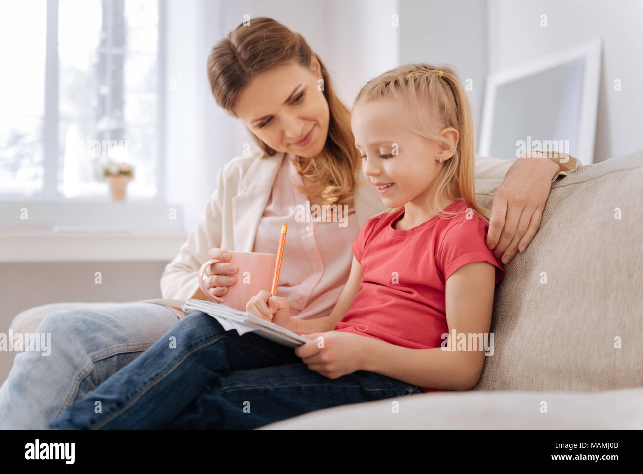 Cheerful young girl studying at home Stock Photo - Alamy