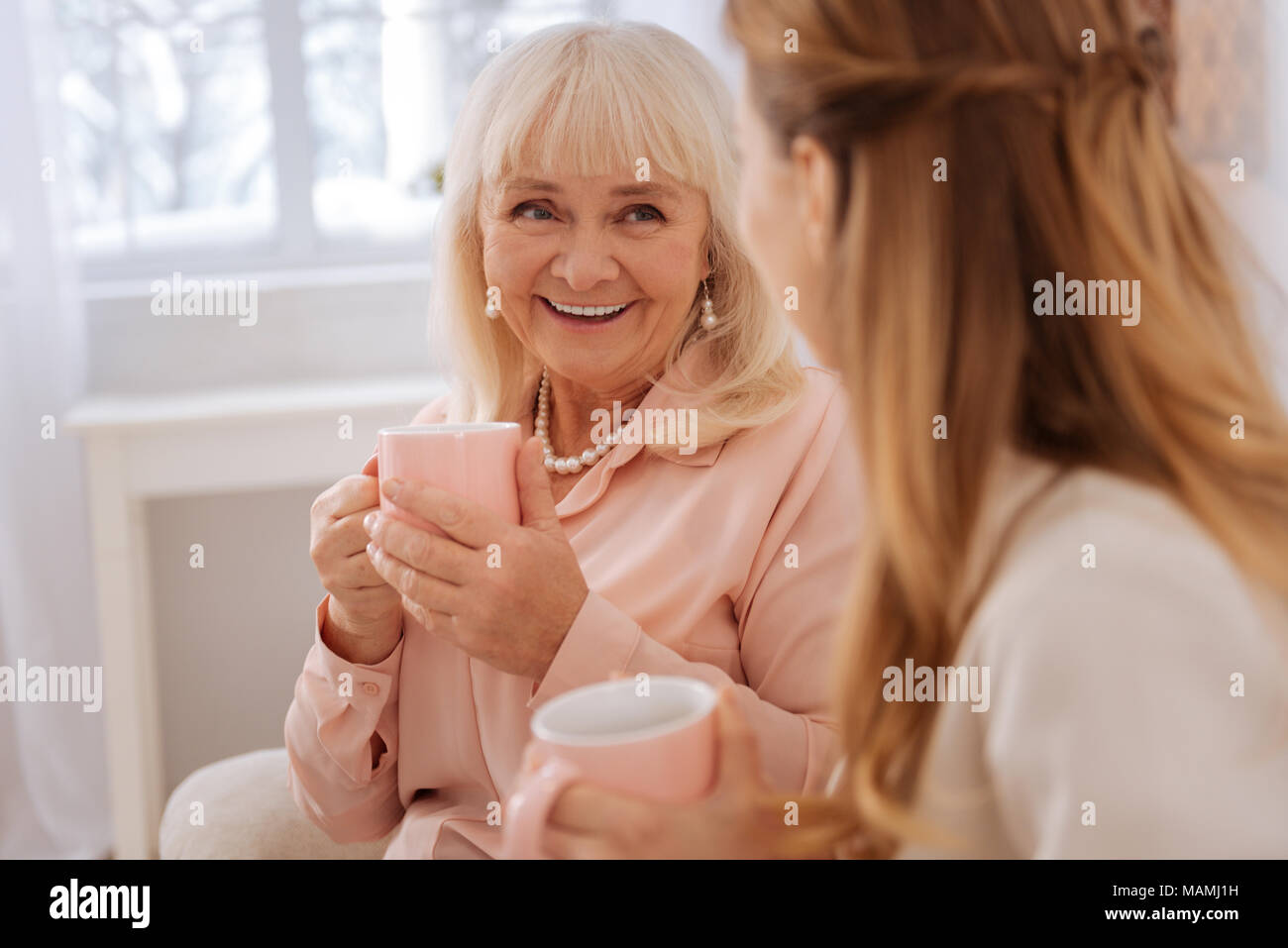 Happy delighted woman smiling Stock Photo - Alamy