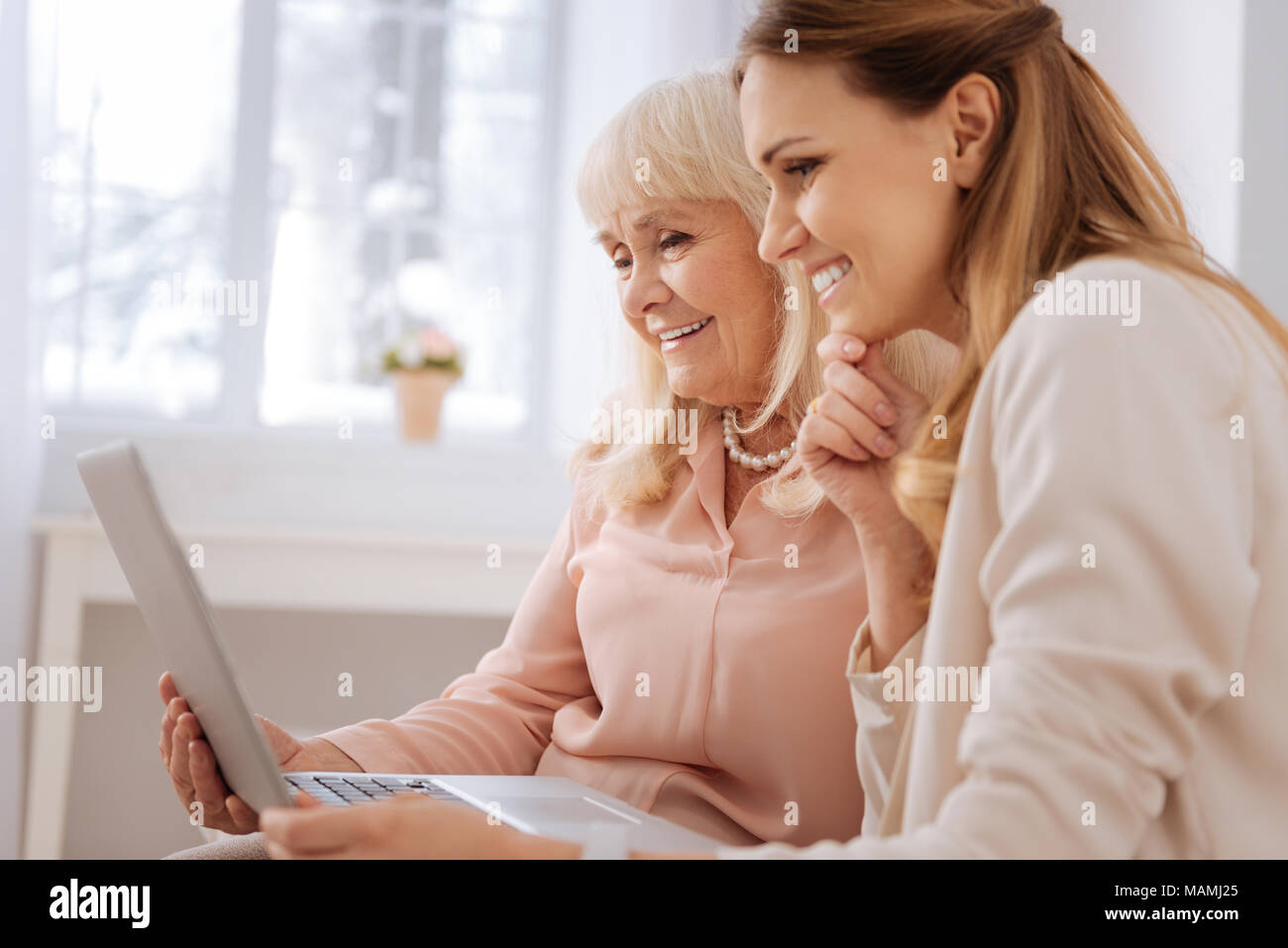 Beautiful delighted woman holding her chin Stock Photo - Alamy