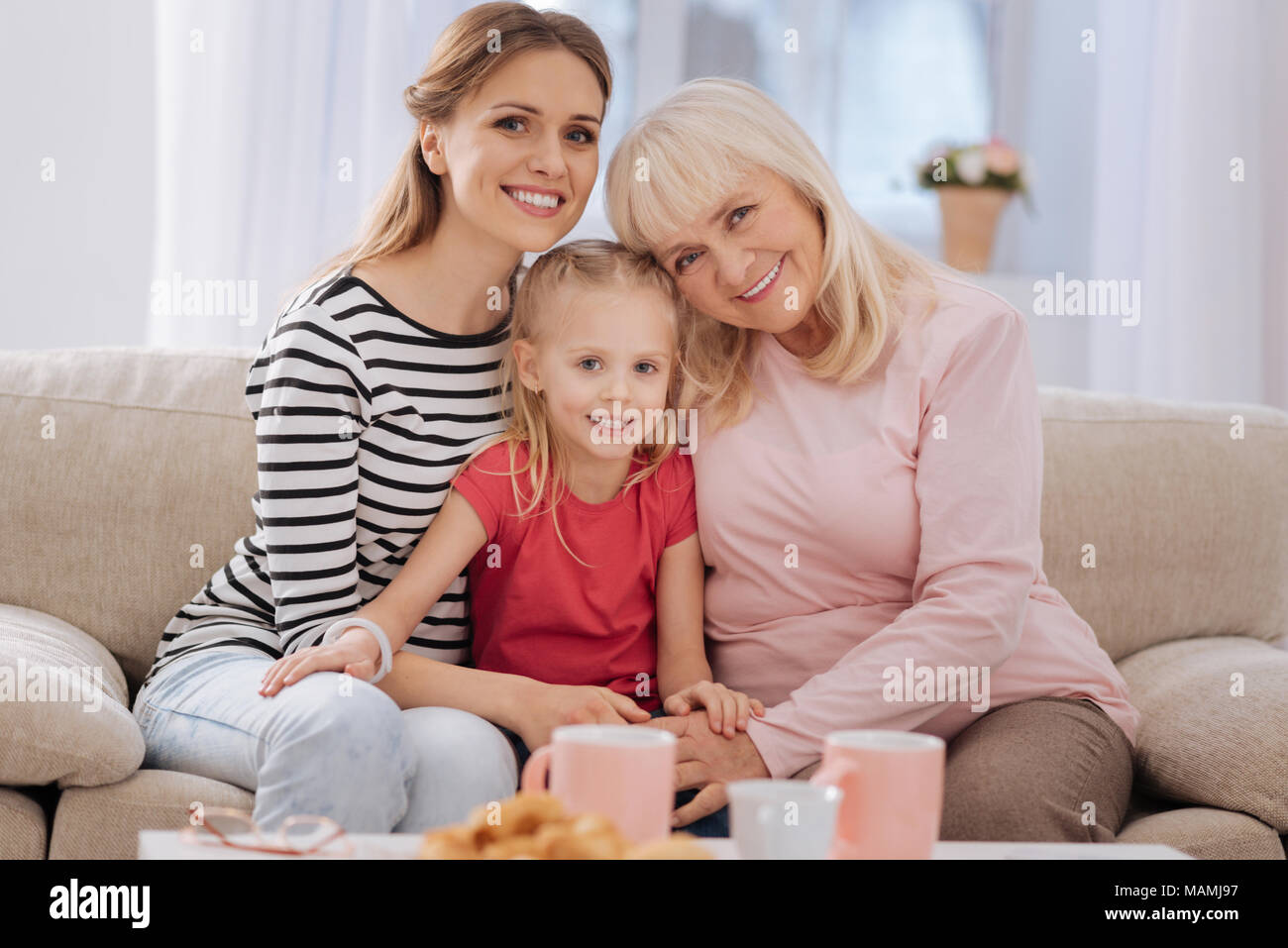Nice happy family sitting together Stock Photo - Alamy