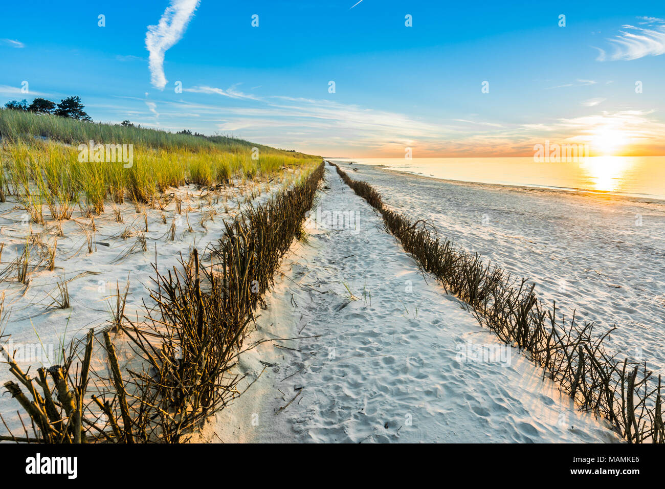 Sandy beach and sunset sky with golden sun shining on white sand Stock ...