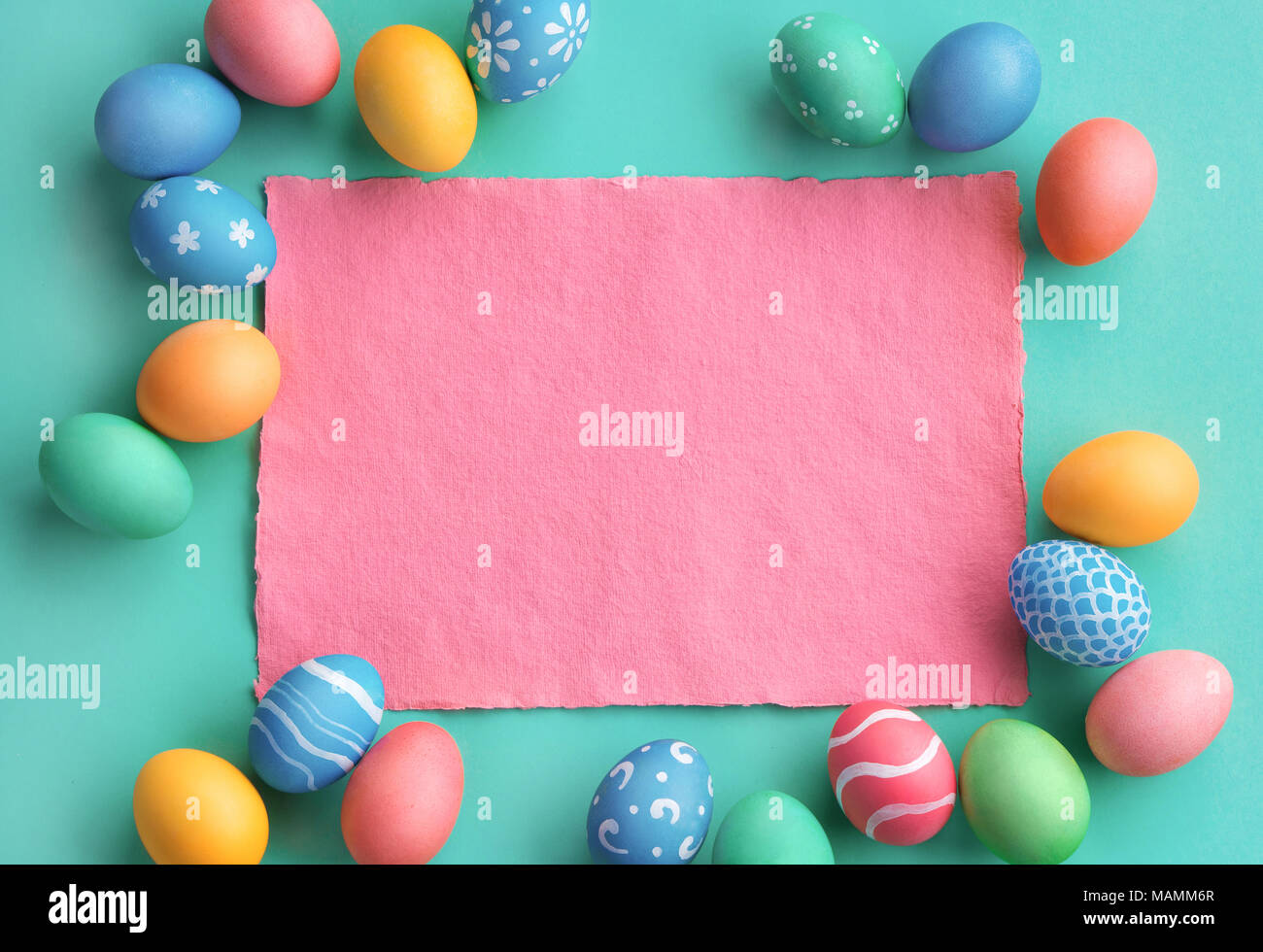 Happy Easter! Turquoise background with colorful easter eggs. Top view ...