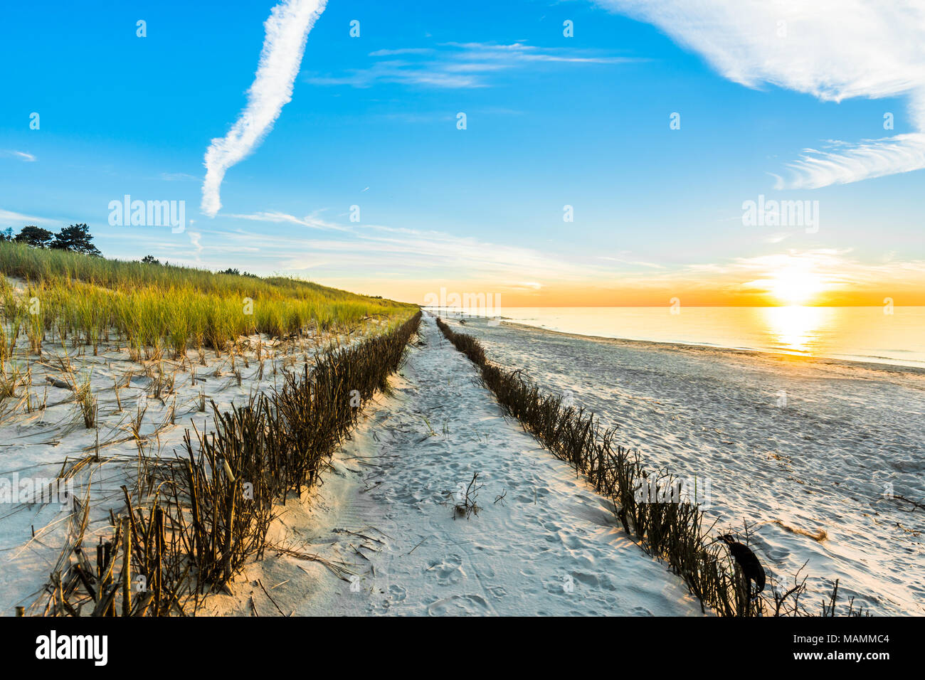 Sandy beach and sunset sky with golden sun shining on white sand Stock ...